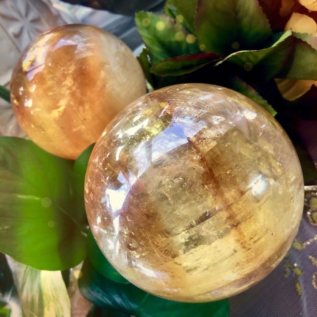 Nurturing Honey Calcite Spheres with Sphere Stand for healing and ease