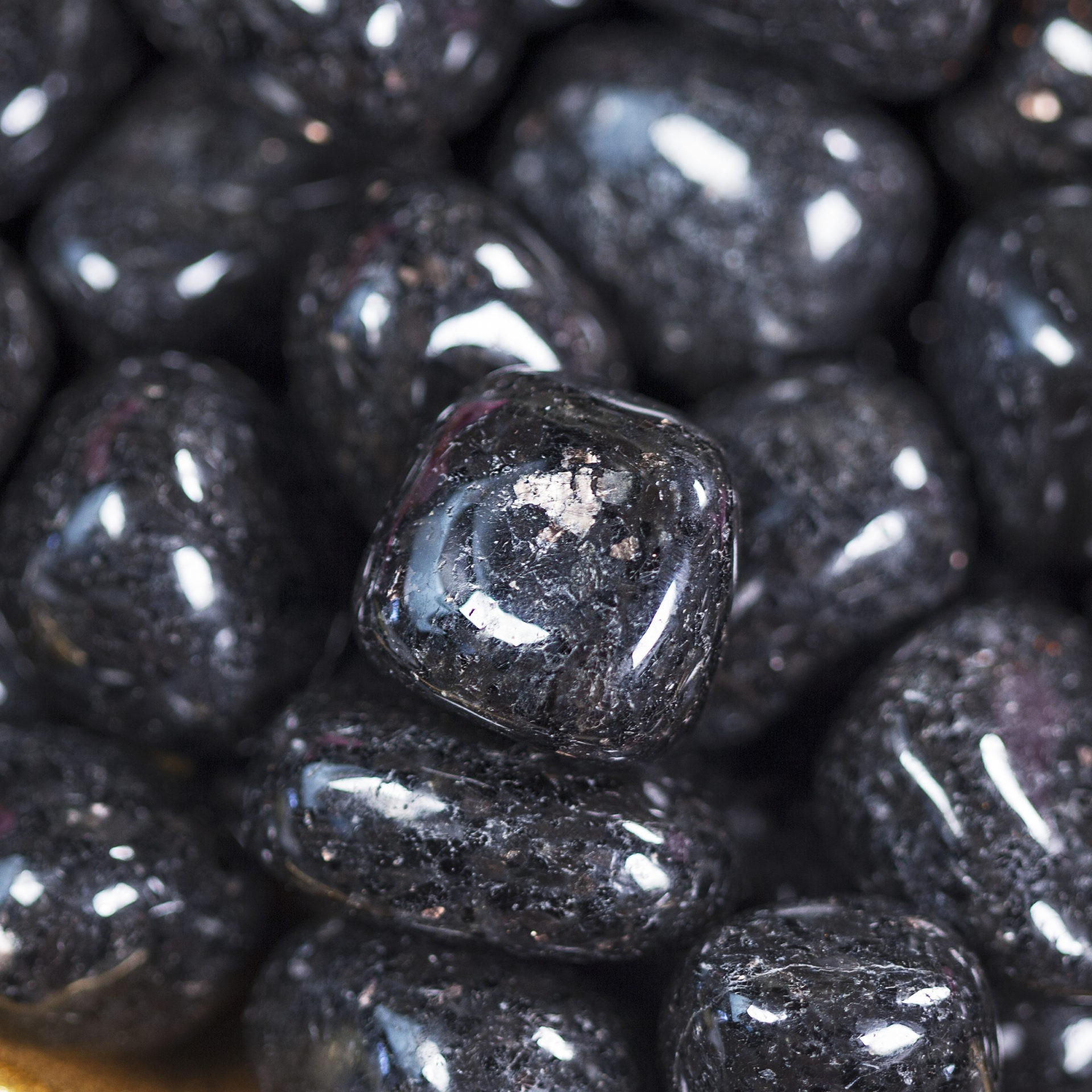 Tumbled Nuummite for healing, protection, and opening the Root Chakra